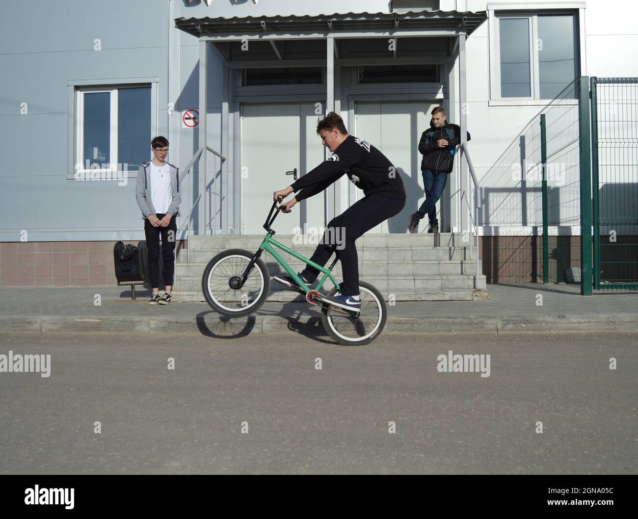 Kovrov, Russia. 9 April 2017. Teen on BMX bike performs a trick near the shopping center Rus ...