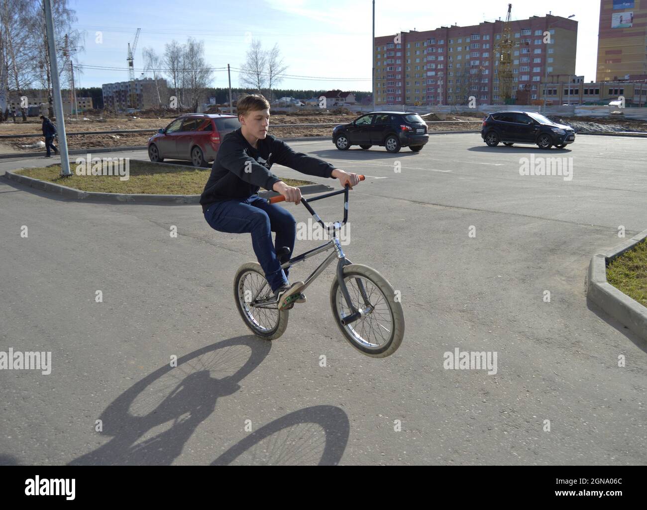 Kovrov, Russia. 9 April 2017. Teen on BMX bike performs a trick near the shopping center Rus ...