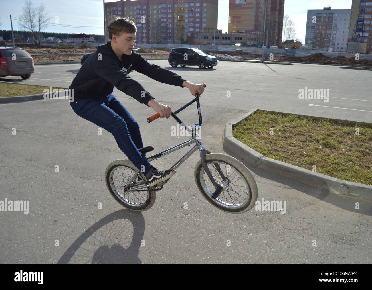 Kovrov, Russia. 9 April 2017. Teen on BMX bike performs a trick near the shopping center Rus ...