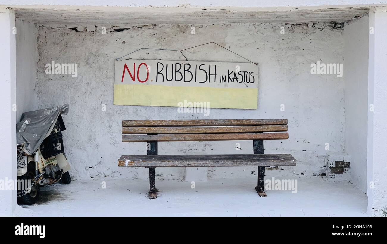 Sign saying "no rubbish" on the wall of an abandoned little shack with ...