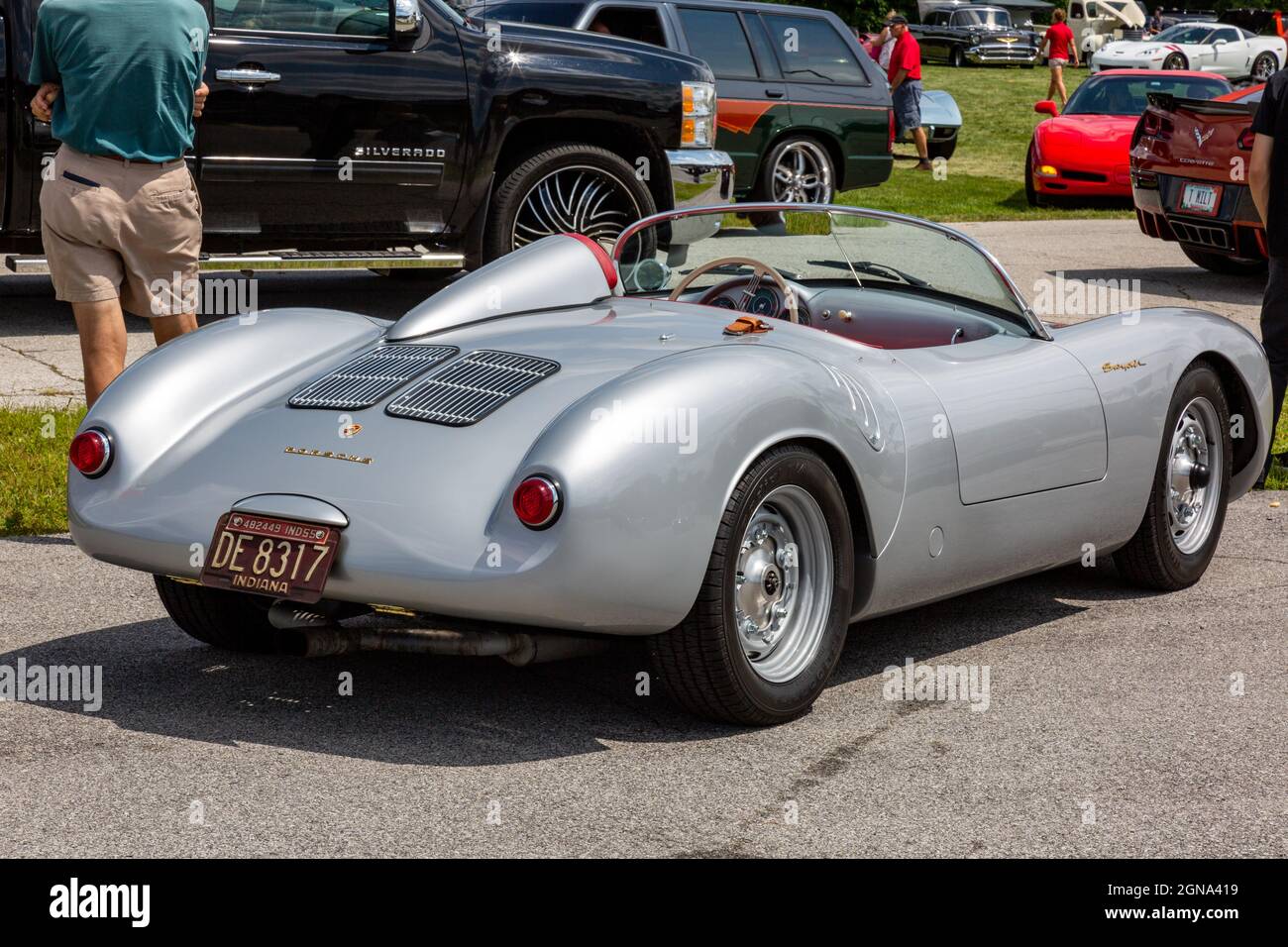 A silver 1955 Porsche 550 Spyder replica on display at a car show in ...