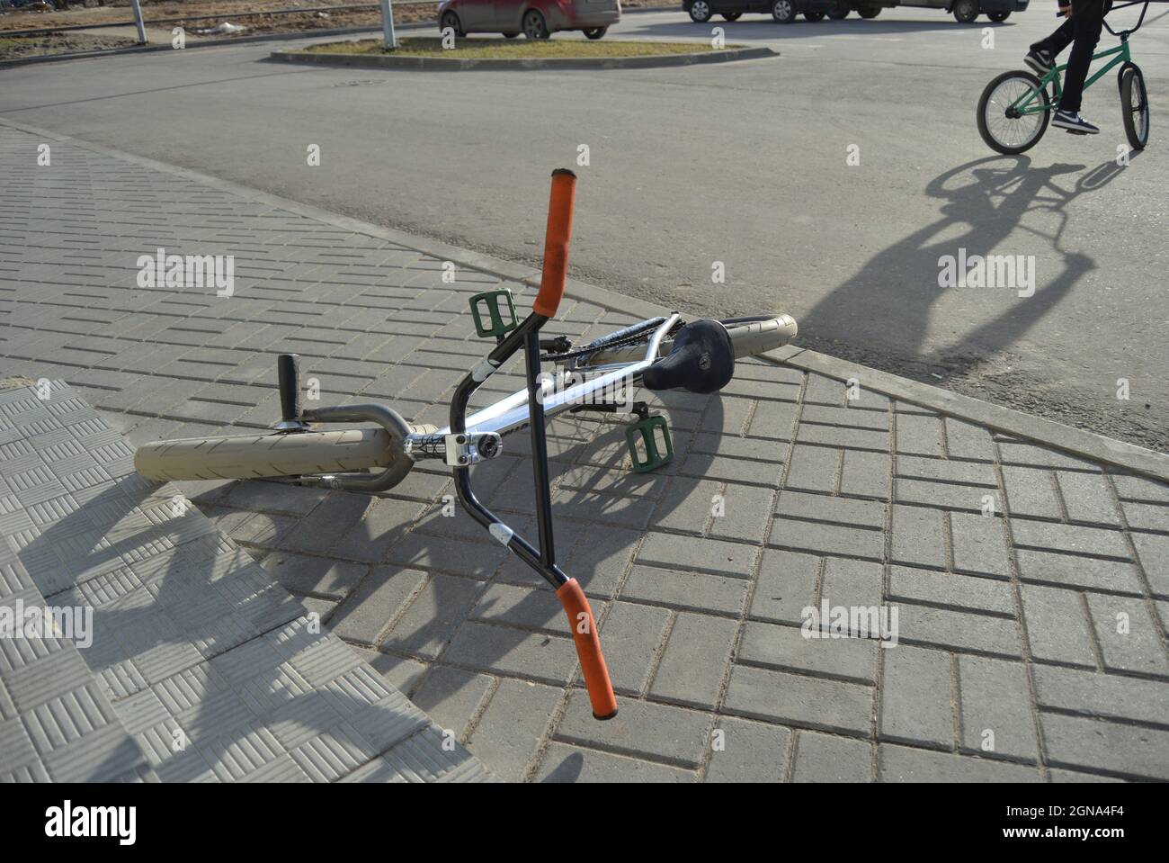 Kovrov, Russia. 9 April 2017. Teens on BMX bikes near the shopping center Rus. BMX bike lying on ...