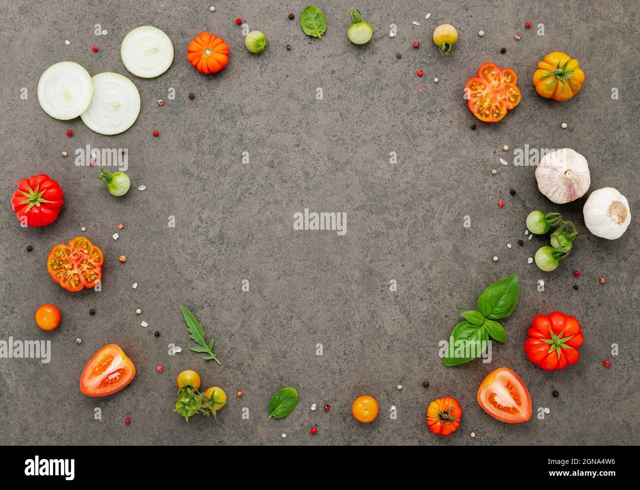 The ingredients for homemade pizza set up on dark stone background ...