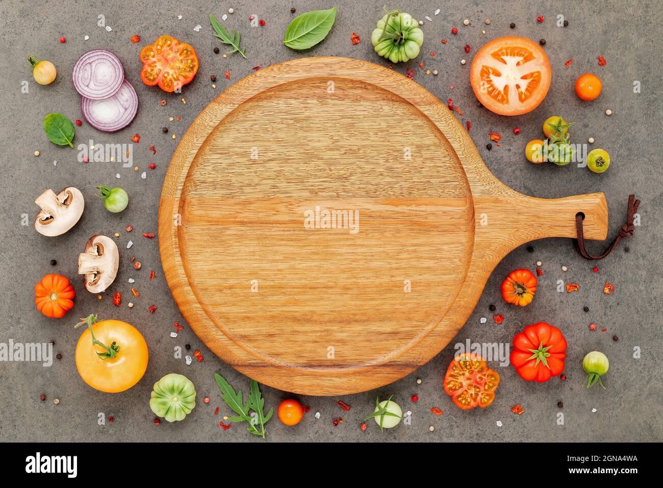 The ingredients for homemade pizza set up on dark stone background ...