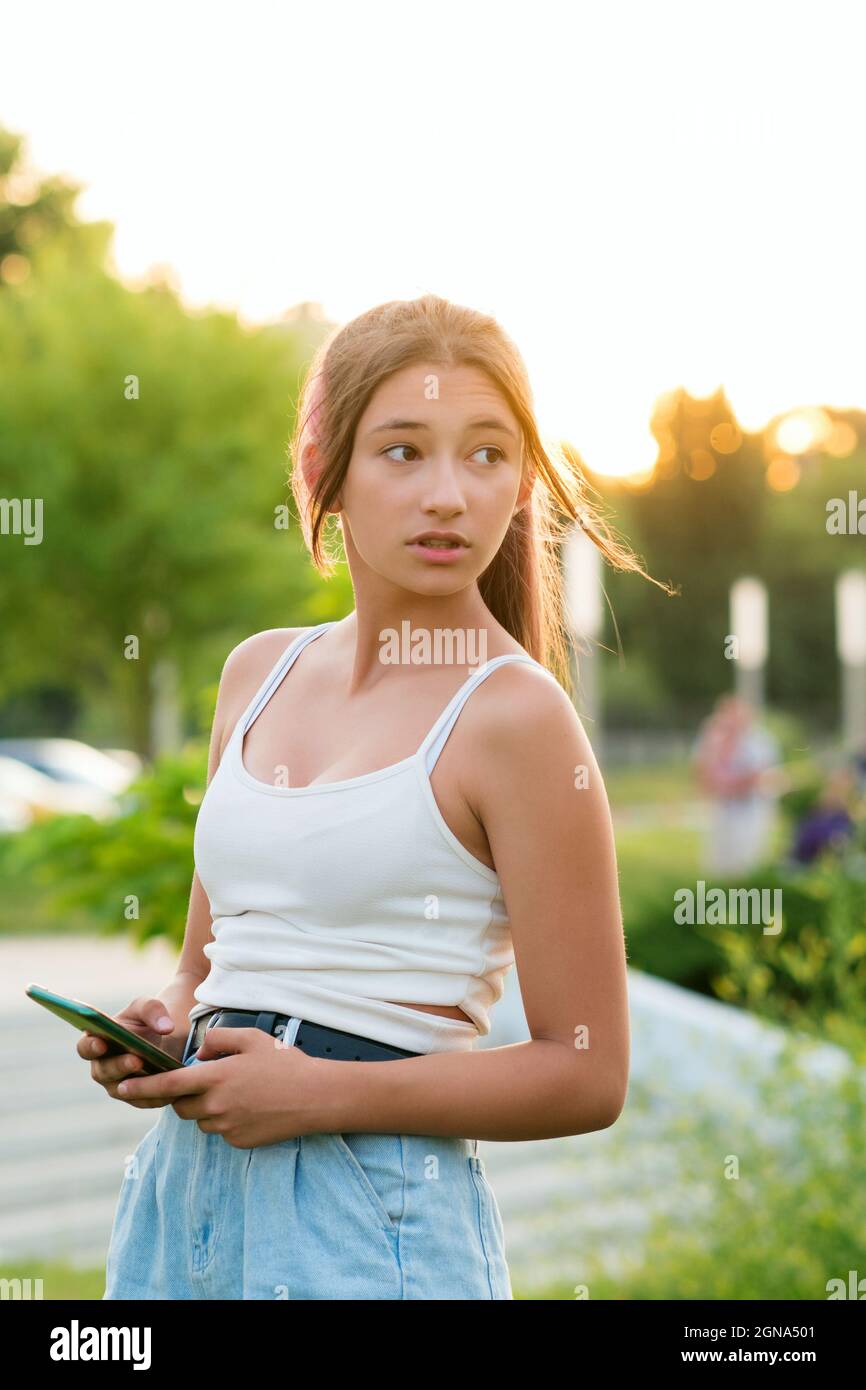Teen girl uses smartphone. Emails, surfing internet. Always connected Stock Photo - Alamy