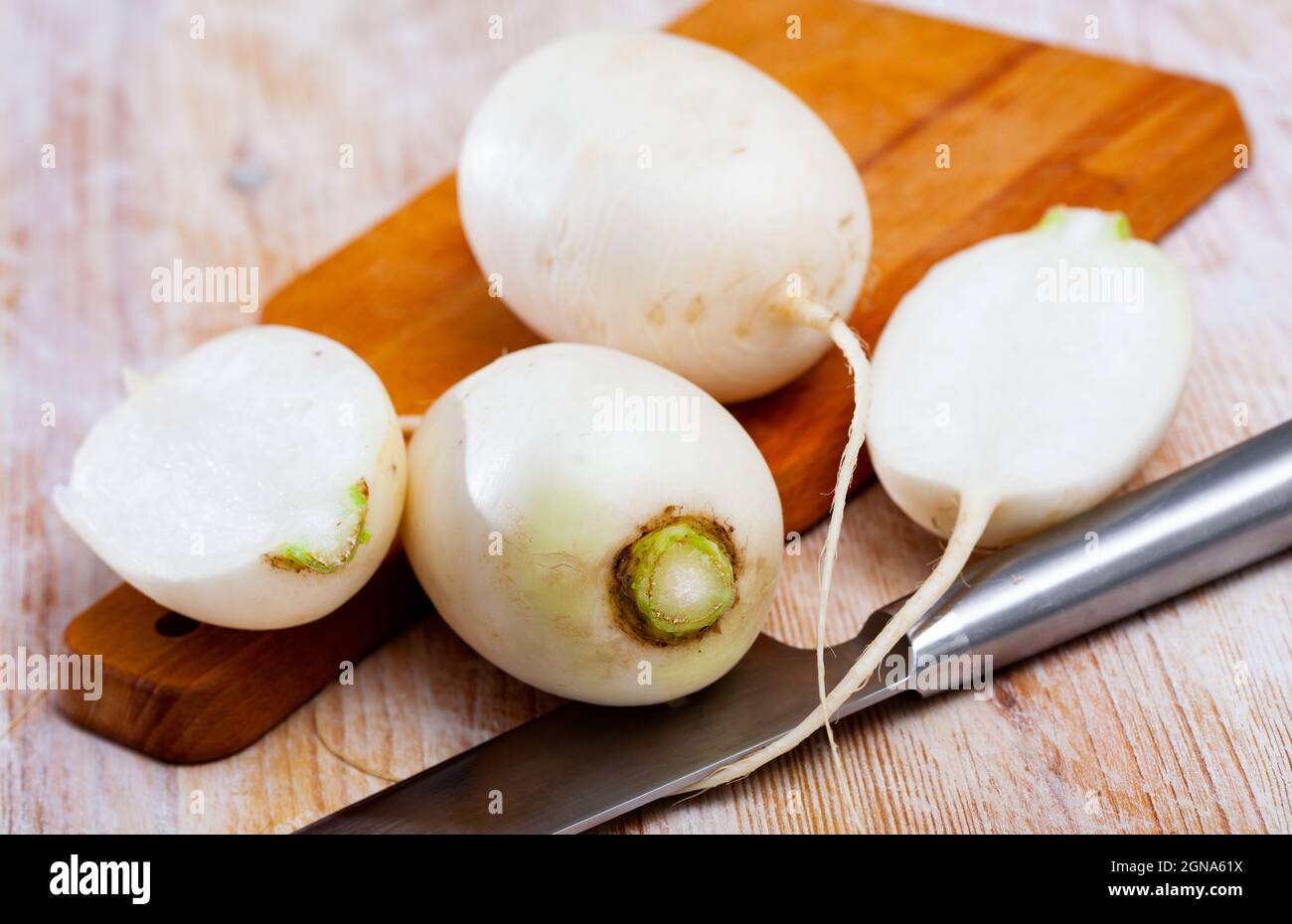 Raw white turnip cut on wooden background, nobody Stock Photo - Alamy