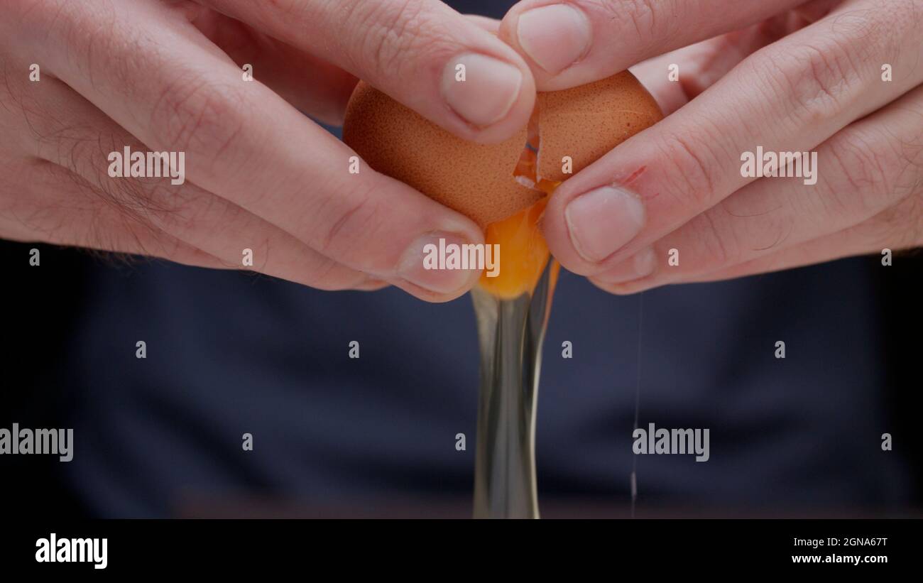 Macro close up of hands breaking egg crack cooking chef poutry Stock ...