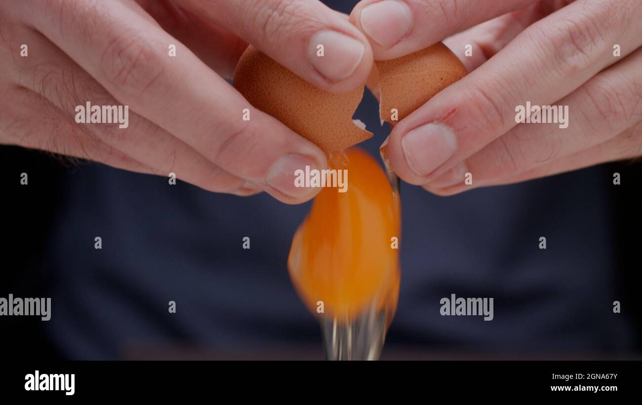 Macro close up of hands breaking egg crack cooking chef poutry Stock ...