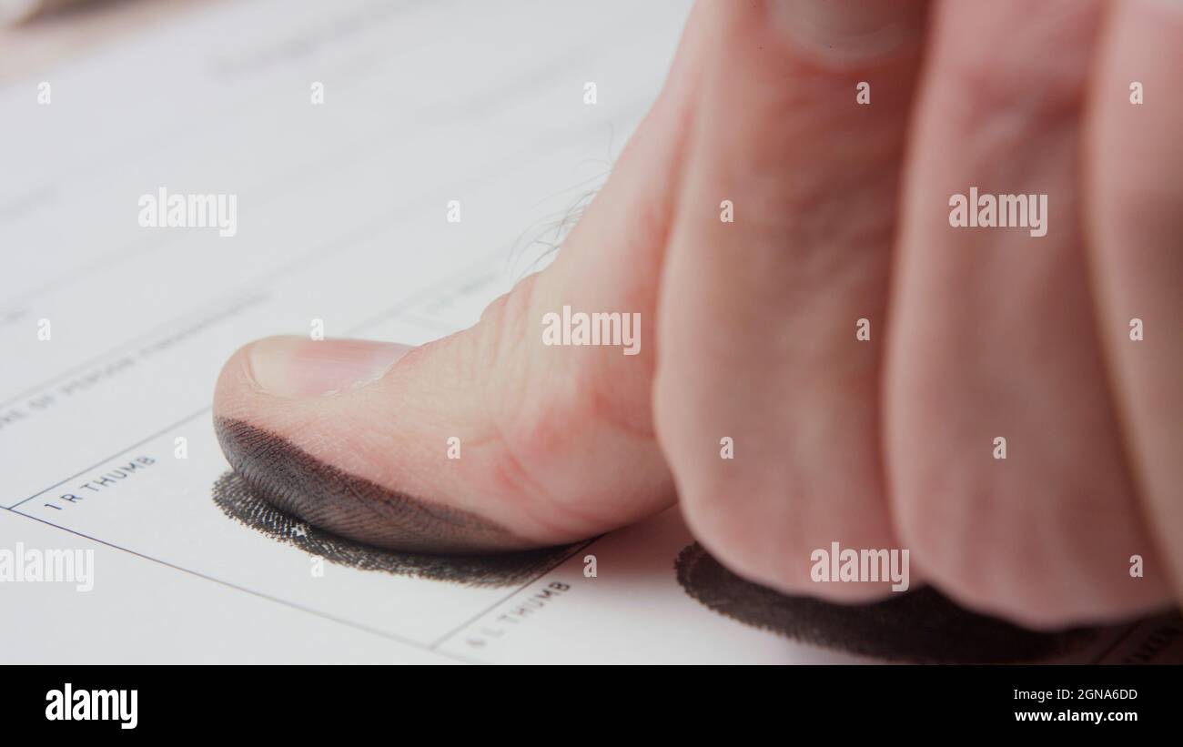 Close up macro of fingerprint registration form filling finger ink ...