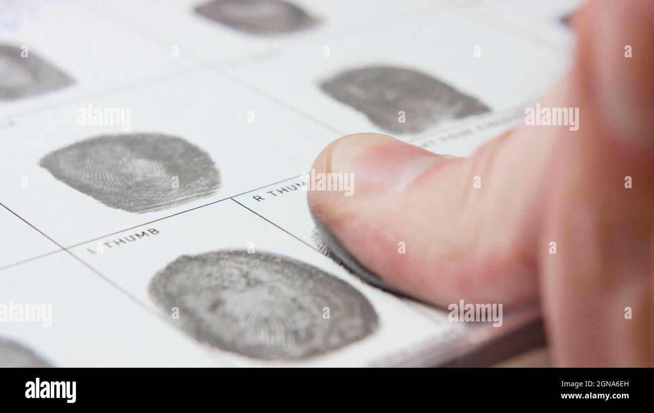Close up macro of fingerprint registration form filling finger ink ...