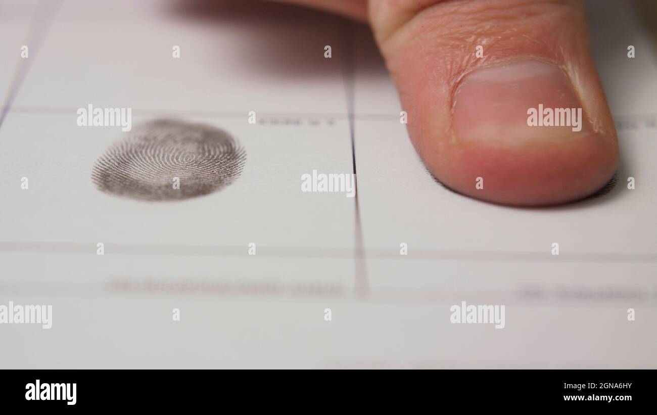Close up macro of fingerprint registration form filling finger ink ...