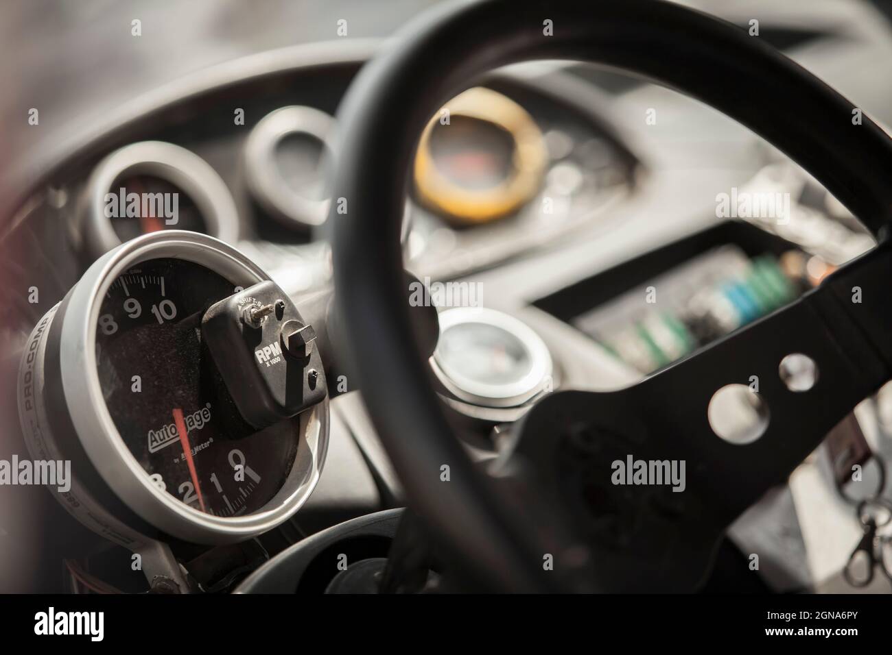 Rally car dashboard gauges and steering wheel close up macro, switches ...