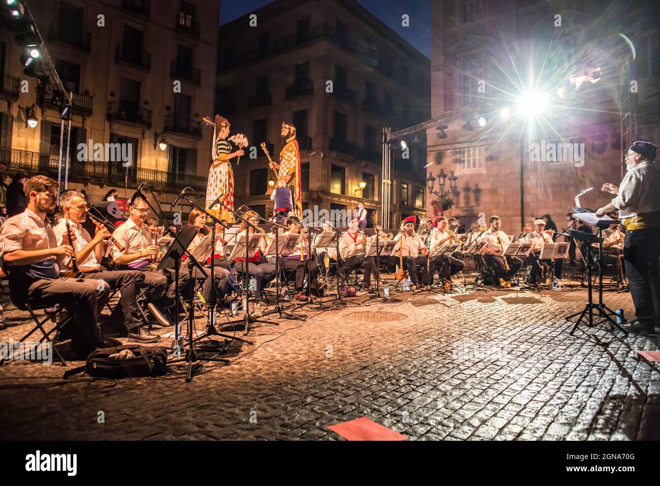 Musicians playing typical Catalan instruments in front of giant dolls ...