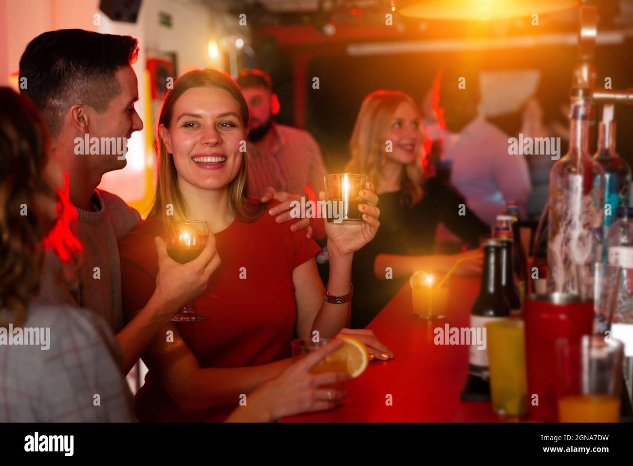 Friends drinking cocktails chatting together hi-res stock photography ...