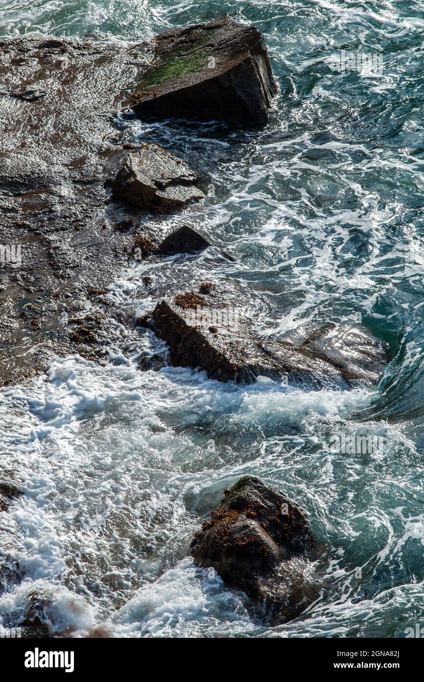 Telephoto of violent water clashing on rocks Stock Photo - Alamy