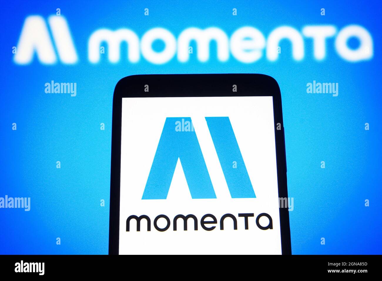 Ukraine. 23rd Sep, 2021. In this photo illustration a Momenta logo is seen on a smartphone and a ...