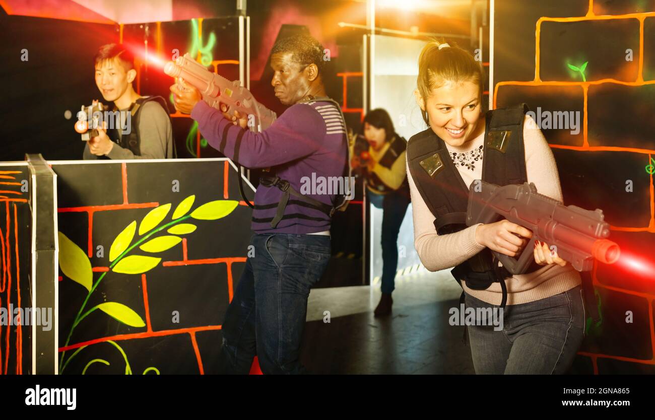 Young man and woman playing laser tag Stock Photo - Alamy