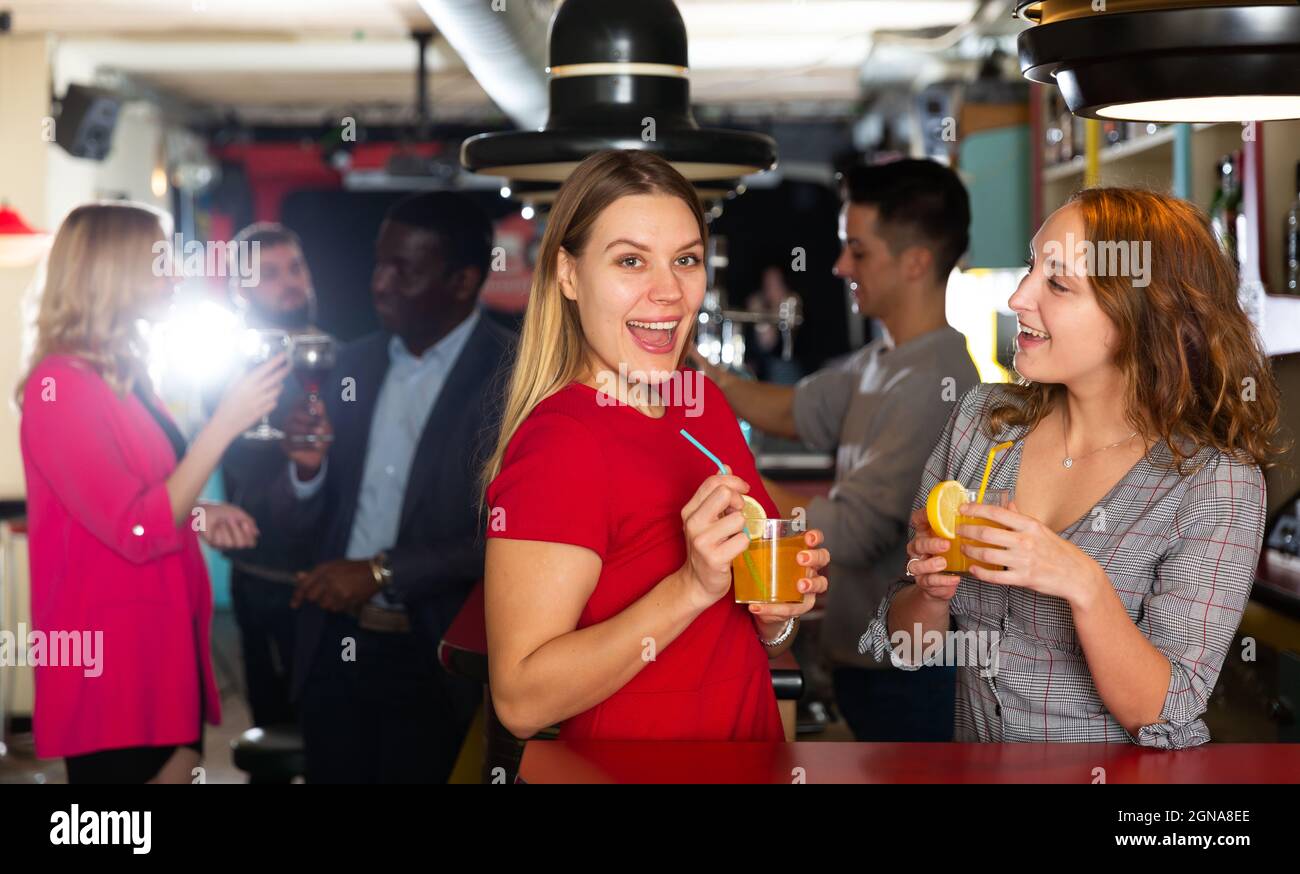 Happy positive females friends with cocktail in the club on party Stock ...