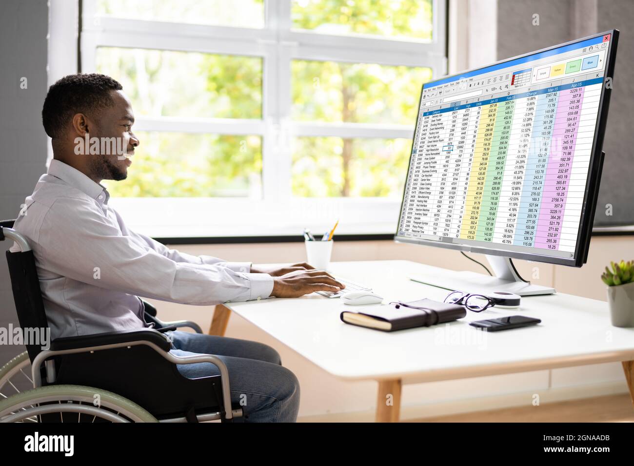 Medical Coding Spreadsheet On PC. African Man In Wheelchair Stock Photo ...