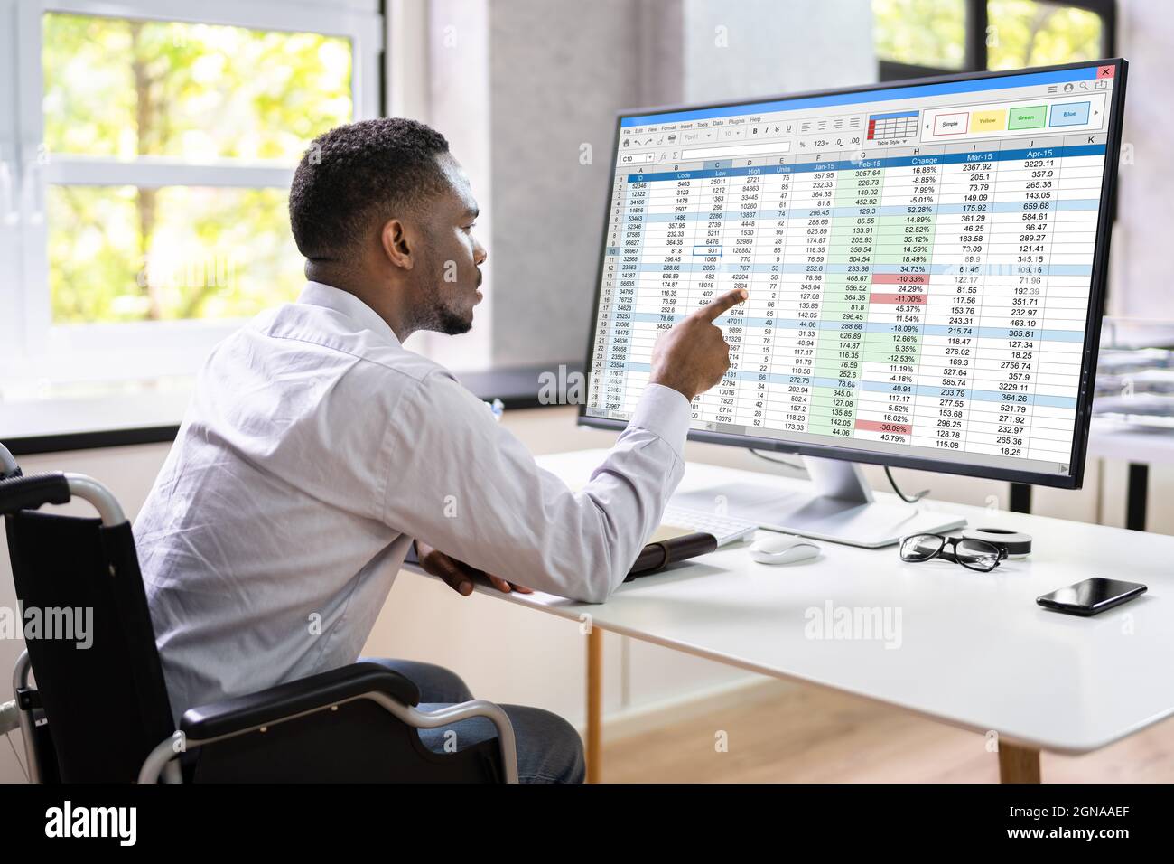Medical Coding Spreadsheet On PC. African Man In Wheelchair Stock Photo ...