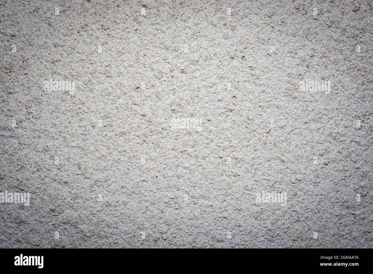 Concrete wall background covered with white rough cement mortar. A ...