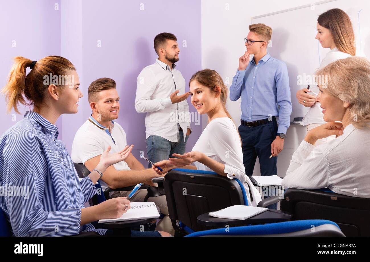 Group of students with teacher in break between lessons indoors Stock ...