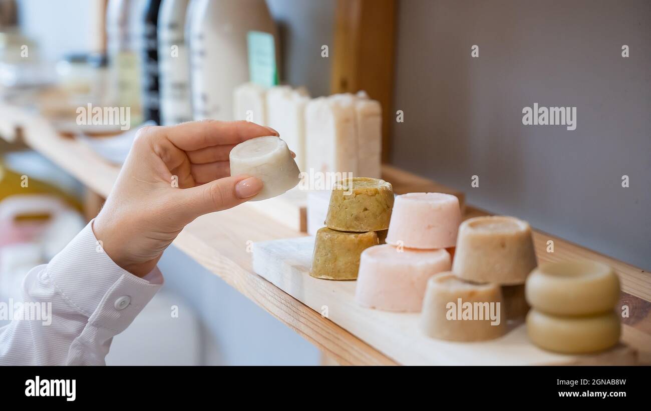 Woman chooses organic soap in eco friendly store Stock Photo - Alamy