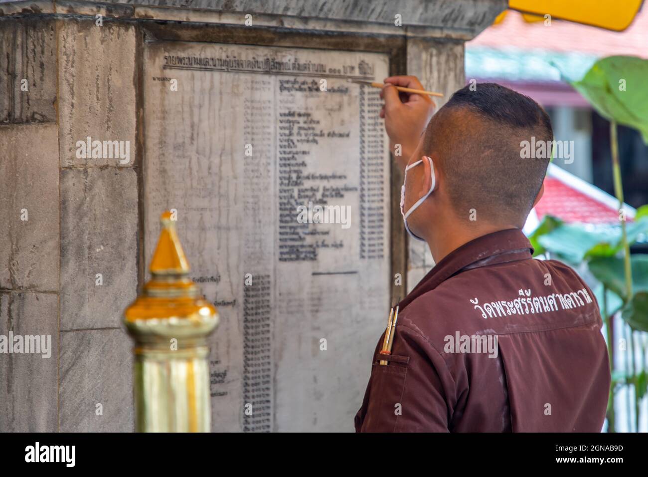 Bangkok, Thailand - Jun 19, 2020 : Temple staff is writing the donator ...