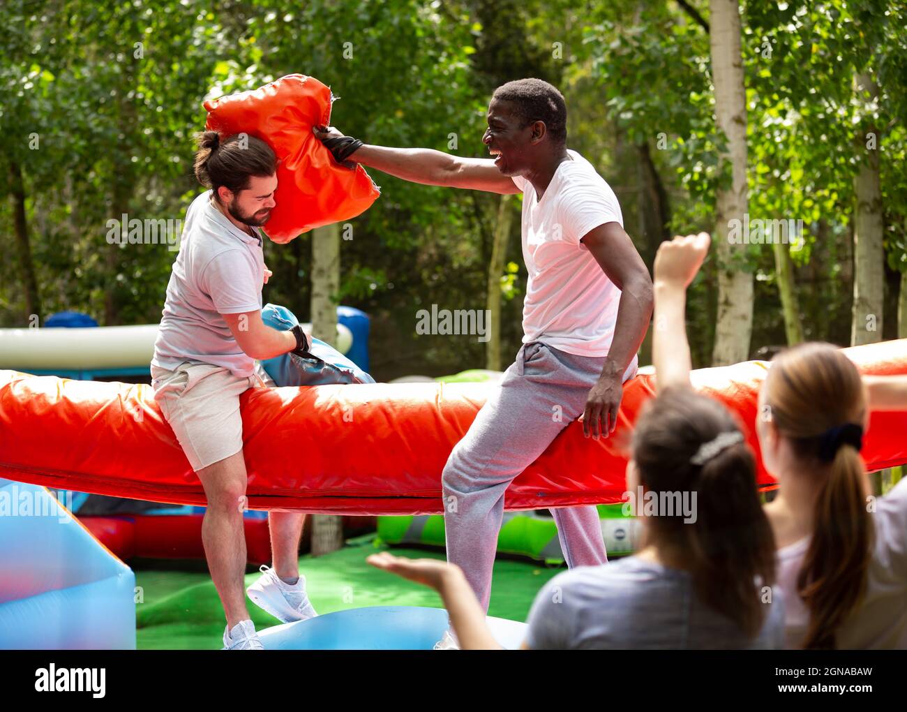 Men on inflatable pillow fight arena Stock Photo - Alamy