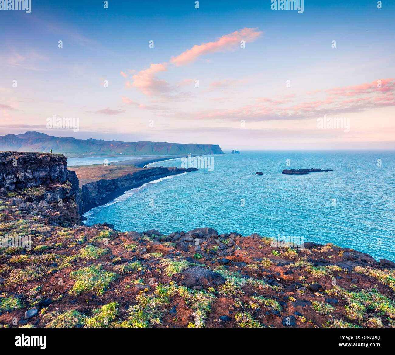 Colorful summer sunset on the Kirkjufjara beach. Evening view of ...