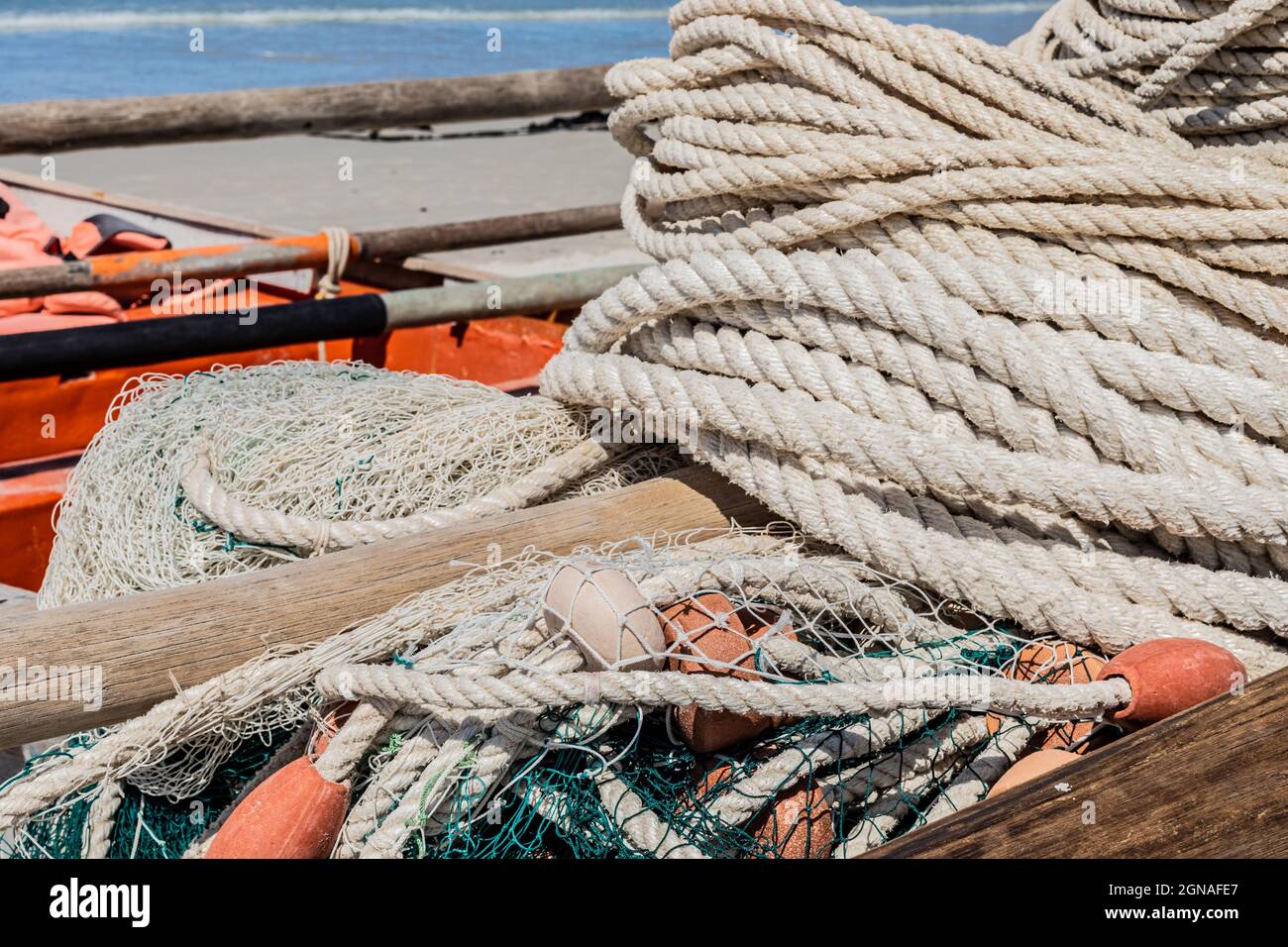 traditional fishing net and rope on small rowing boat on beach Stock ...
