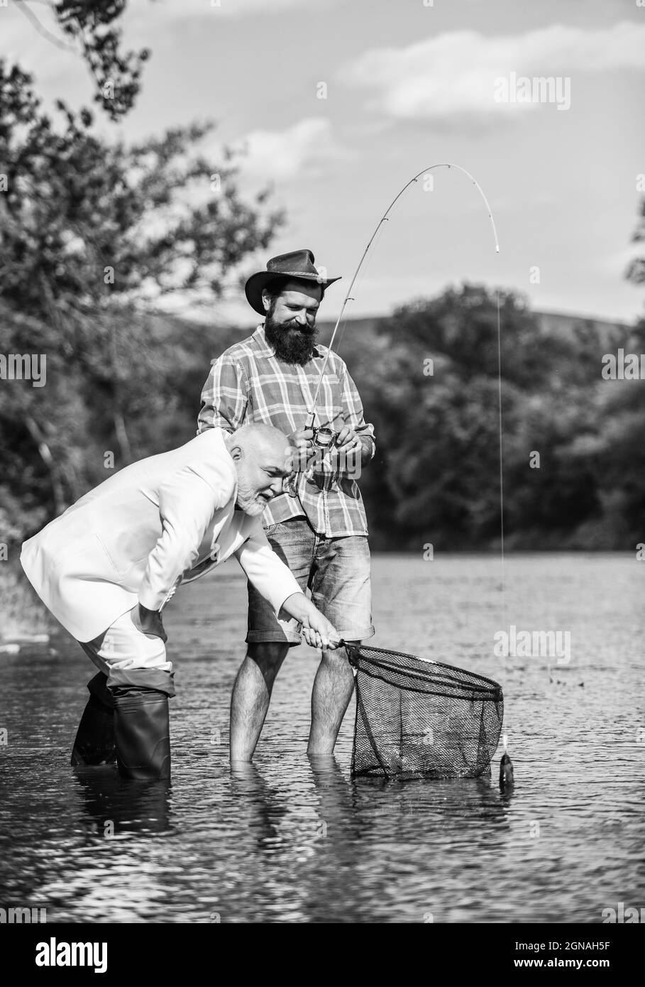 Bearded man and brutal hipster fishing. Family day. Fishing team. Peace ...