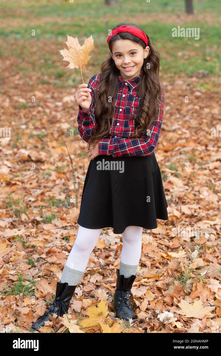happy child in school uniform hold autumn maple leaf outdoor, fall ...