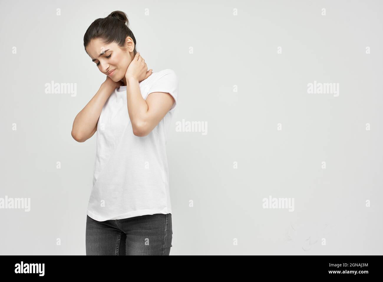 woman holding neck pain medicine migraine treatment Stock Photo - Alamy