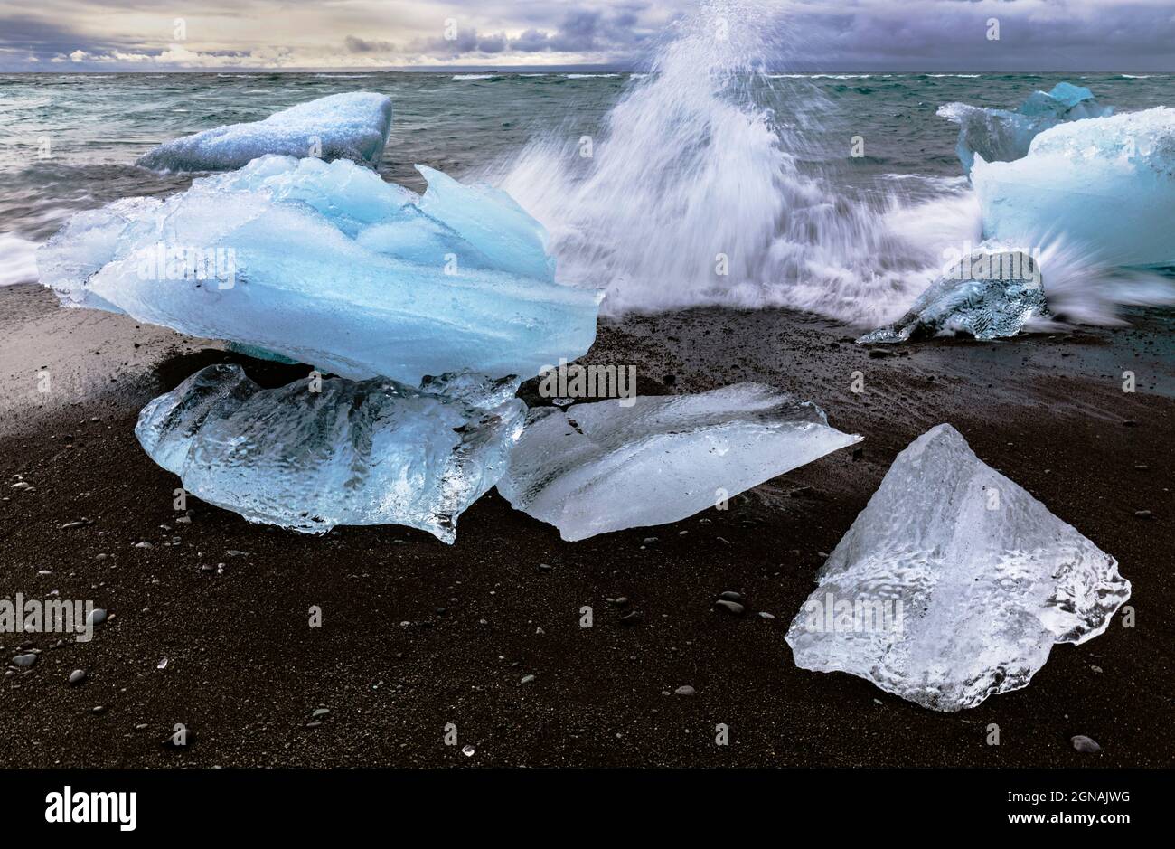 amazing blue colored icebergs washed ashore the black sand beach ...