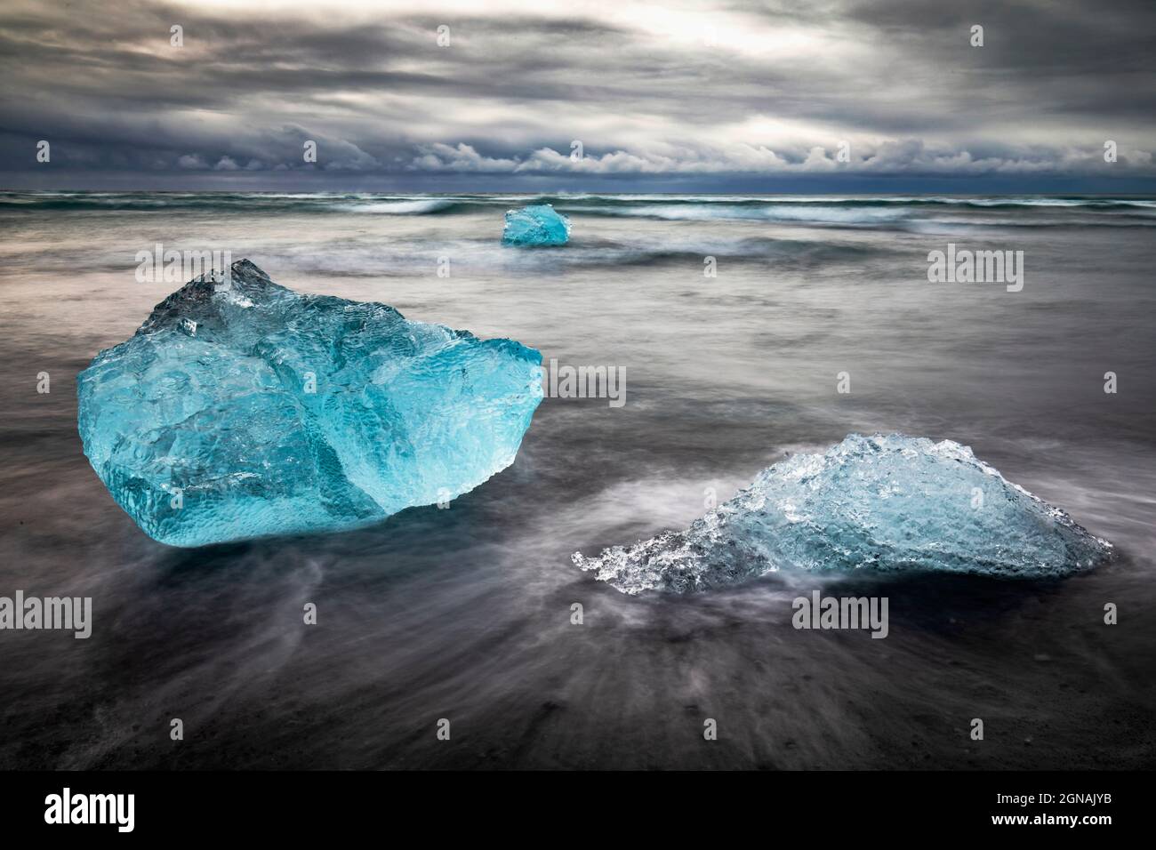 amazing blue colored icebergs washed ashore the black sand beach ...