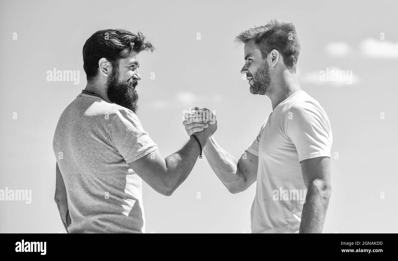 Strong and muscular arms. Successful deal handshake blue sky background ...