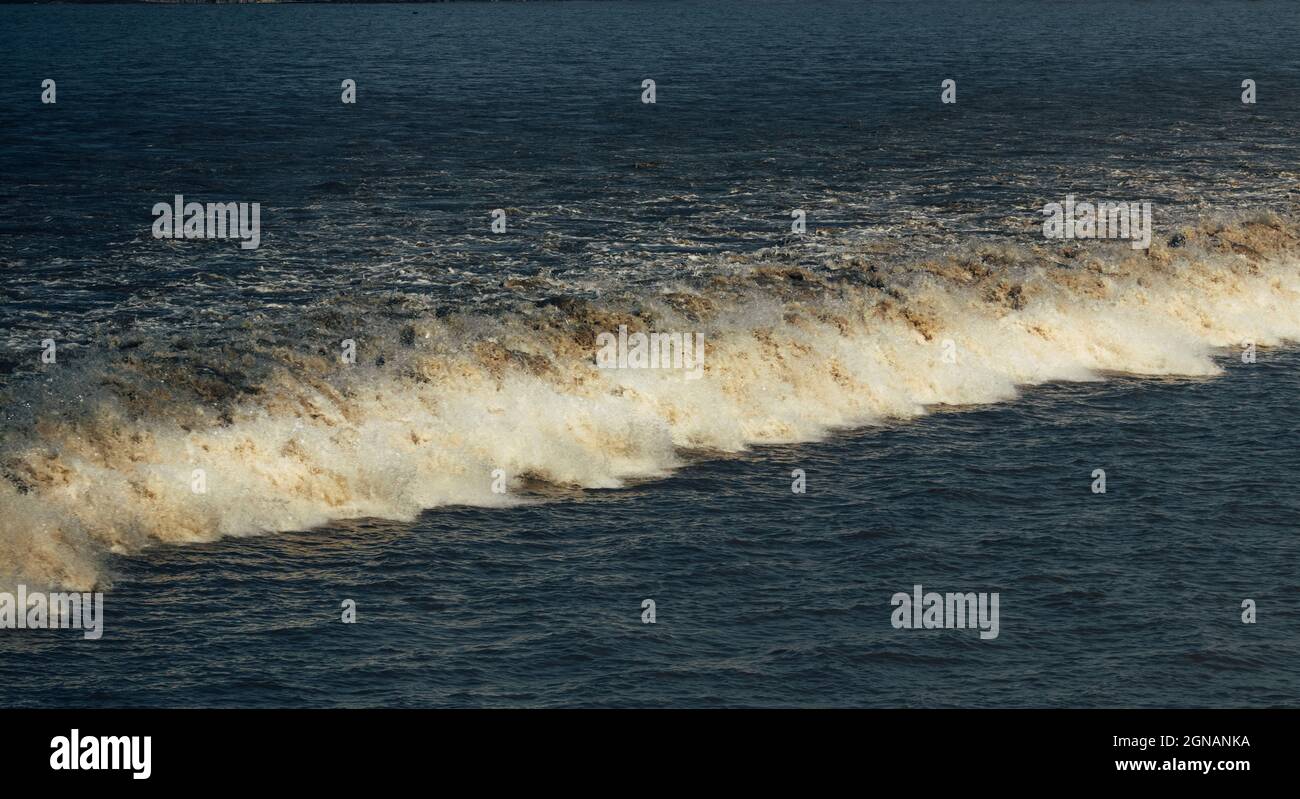 The tide waves are captured at Qiantang River in Hangzhou city, east ...
