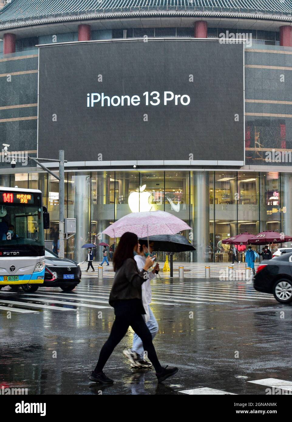 Beijing, China. 24th Sep, 2021. People walk past an apple store in ...