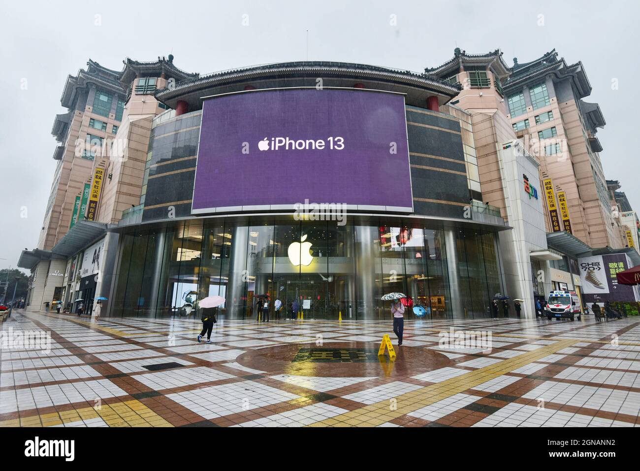 Beijing, China. 24th Sep, 2021. People walk past an apple store in ...