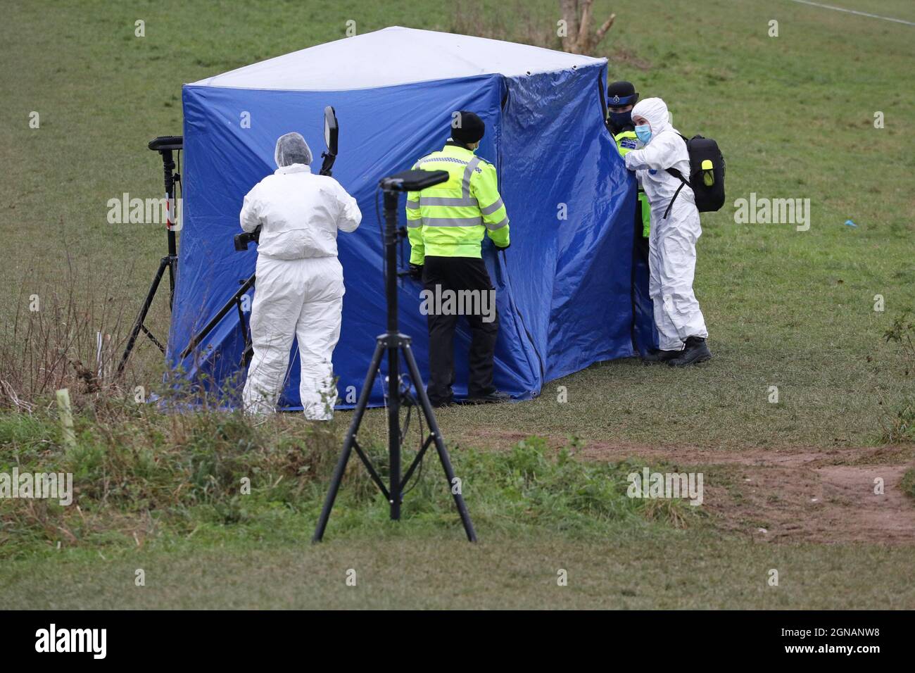 File photo dated 4/1/2021 of investigators at a forensic tent in Bugs ...