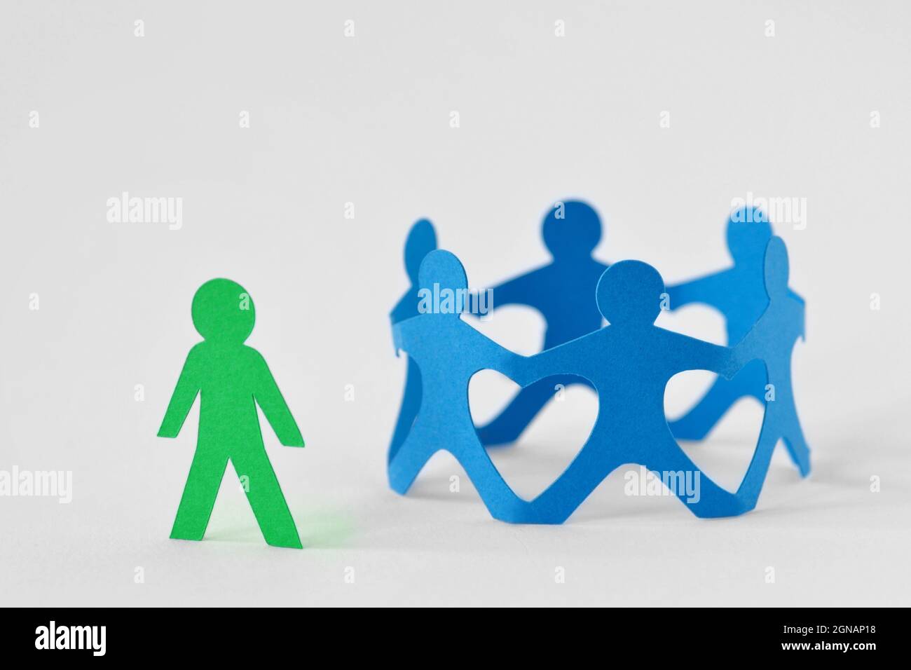 Group of people holding hands in circle and person alone - Concept of ...