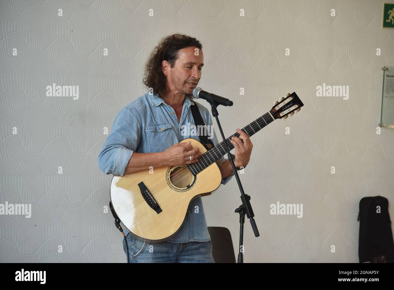 Cologne, Germany. 23rd Sep, 2021. Singer Stephan Brings plays at a ...
