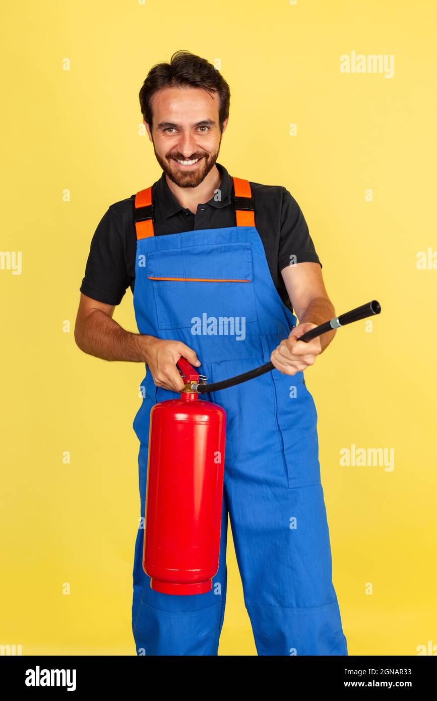 Half-length portrait of smiling young bearded man, male auto mechanic ...