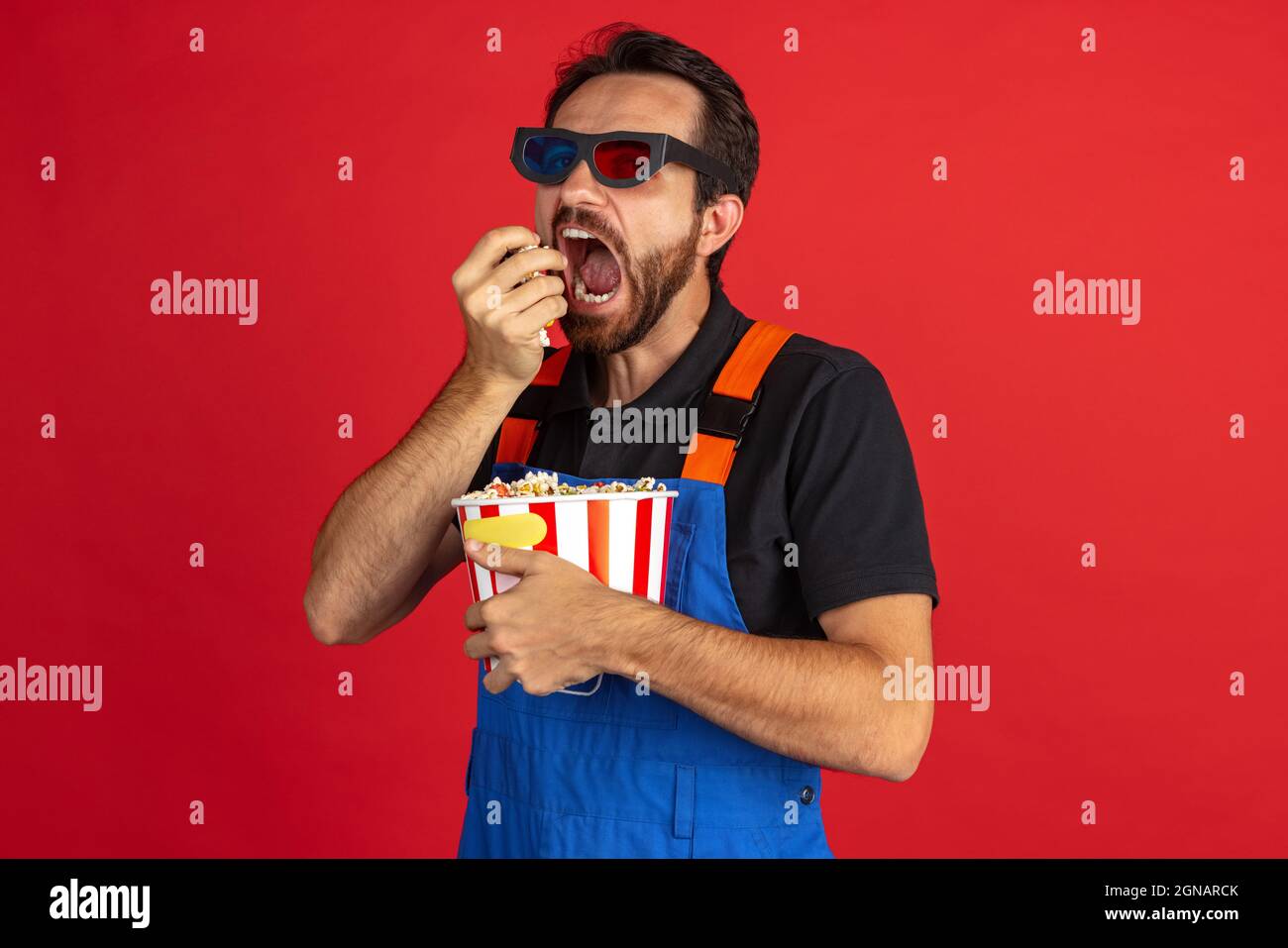 Funny young bearded man, male auto mechanic or fitter wearing blue work ...