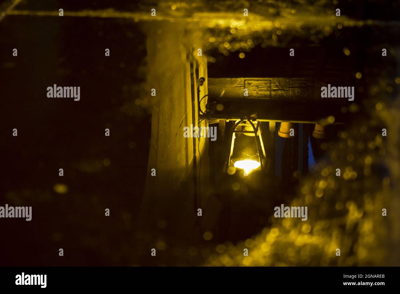 Closeup shot of a puddle reflecting nighttime lighting in the city ...