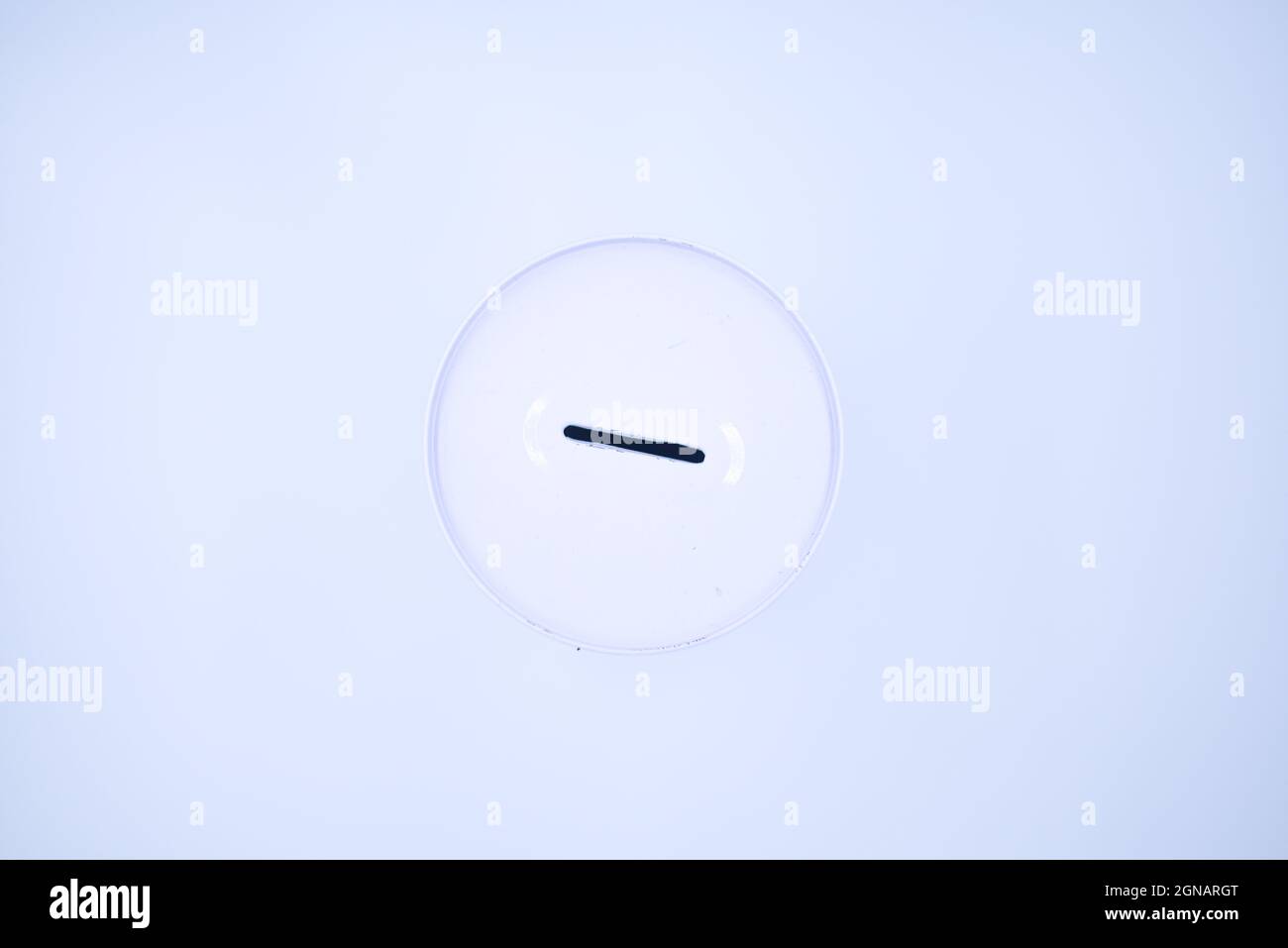 Top-view of money-saving container hole on a bright white surface Stock ...