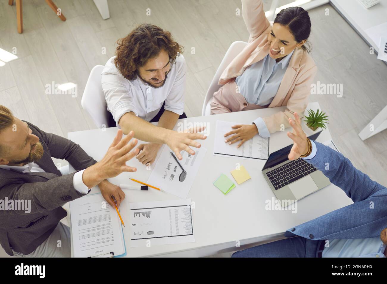 Happy business team celebrating winning a deal and giving each other a ...