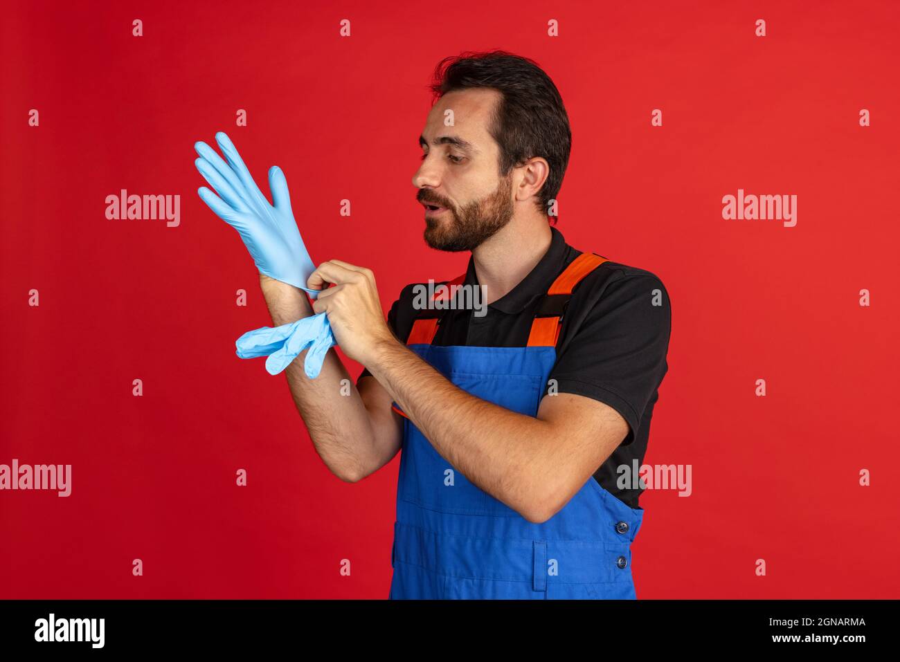 Comic portrait of young bearded man, male auto mechanic or fitter ...