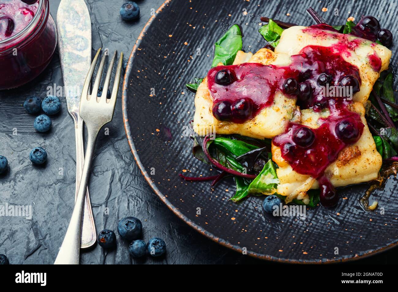 Delicious baked fish with berry sauce. Stewed pangasius with ...